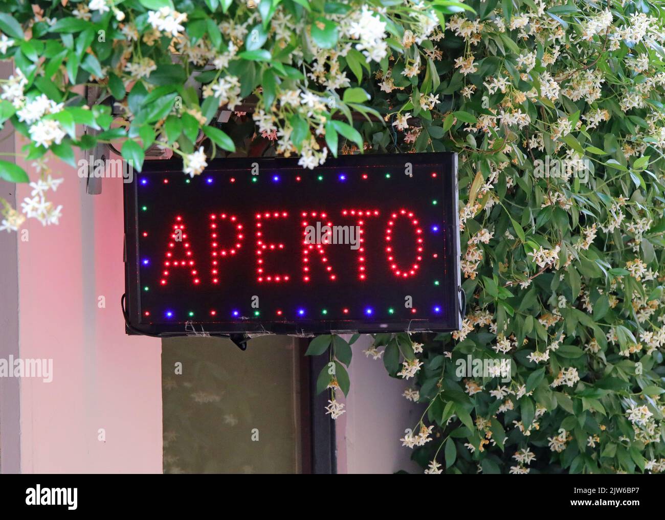 LED lighted sign with the big text APERTO Which means OPEN in the ...
