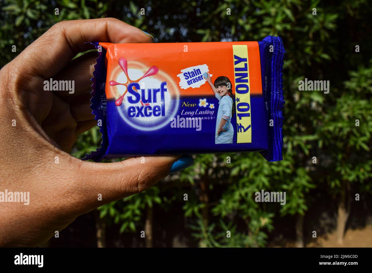 Female holding Fabric wash Surf Excel small package worth rupees 10 ...