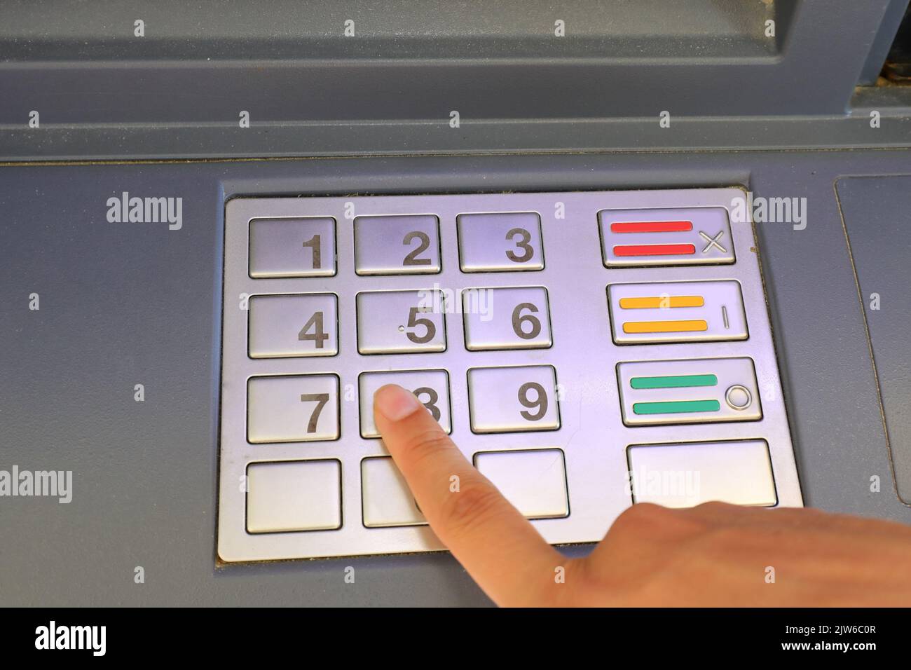 hand of people typing secret code on numeric keypad without being seen ...