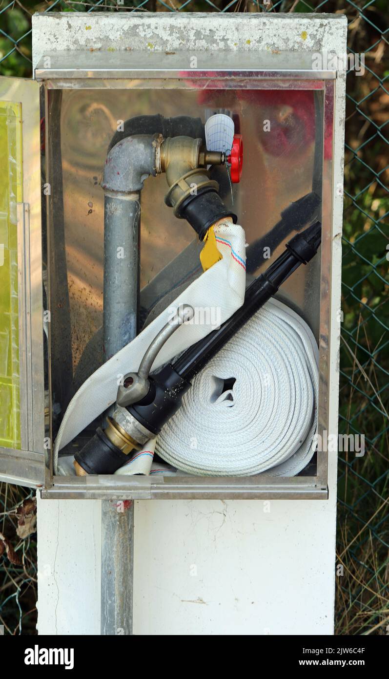 hydrant with hose to put out fires inside the metal box Stock Photo - Alamy
