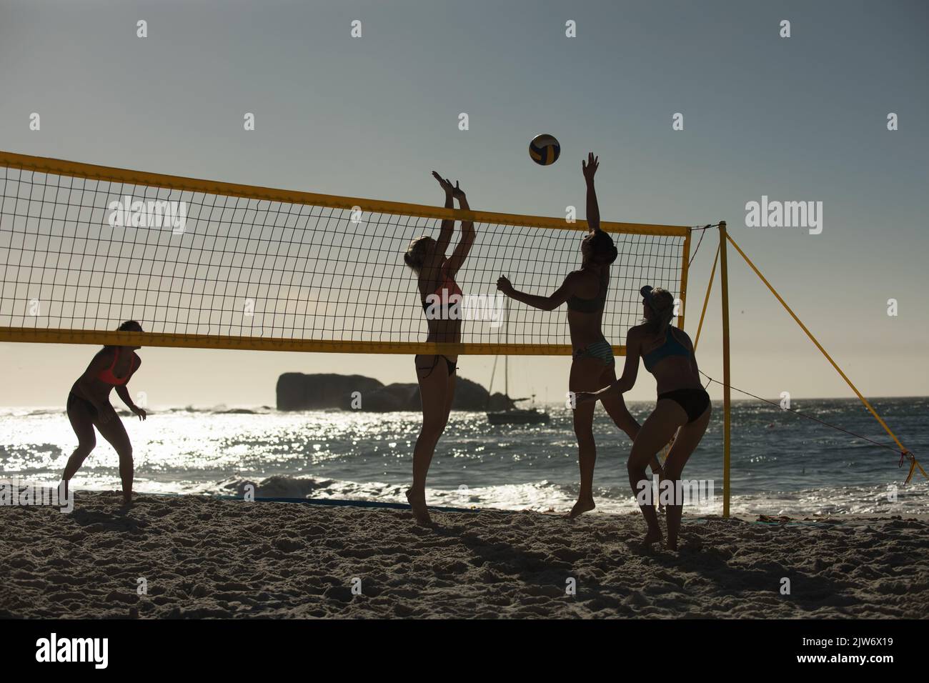 Female volleyball players playing on the beach Stock Photo - Alamy