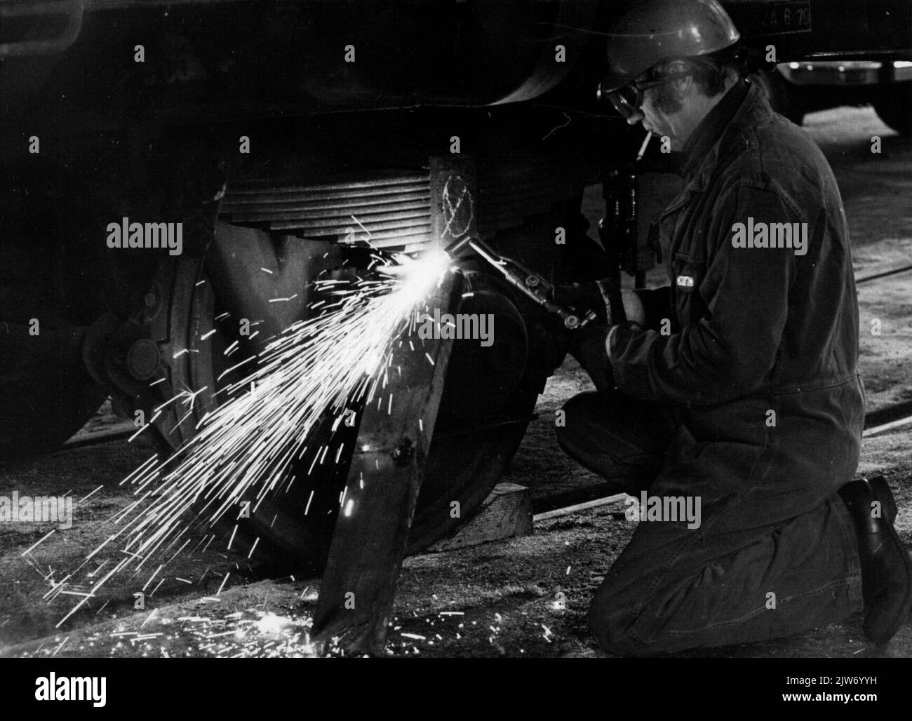 Image of a welder at work at a wheel of a freight wagon in the car ...