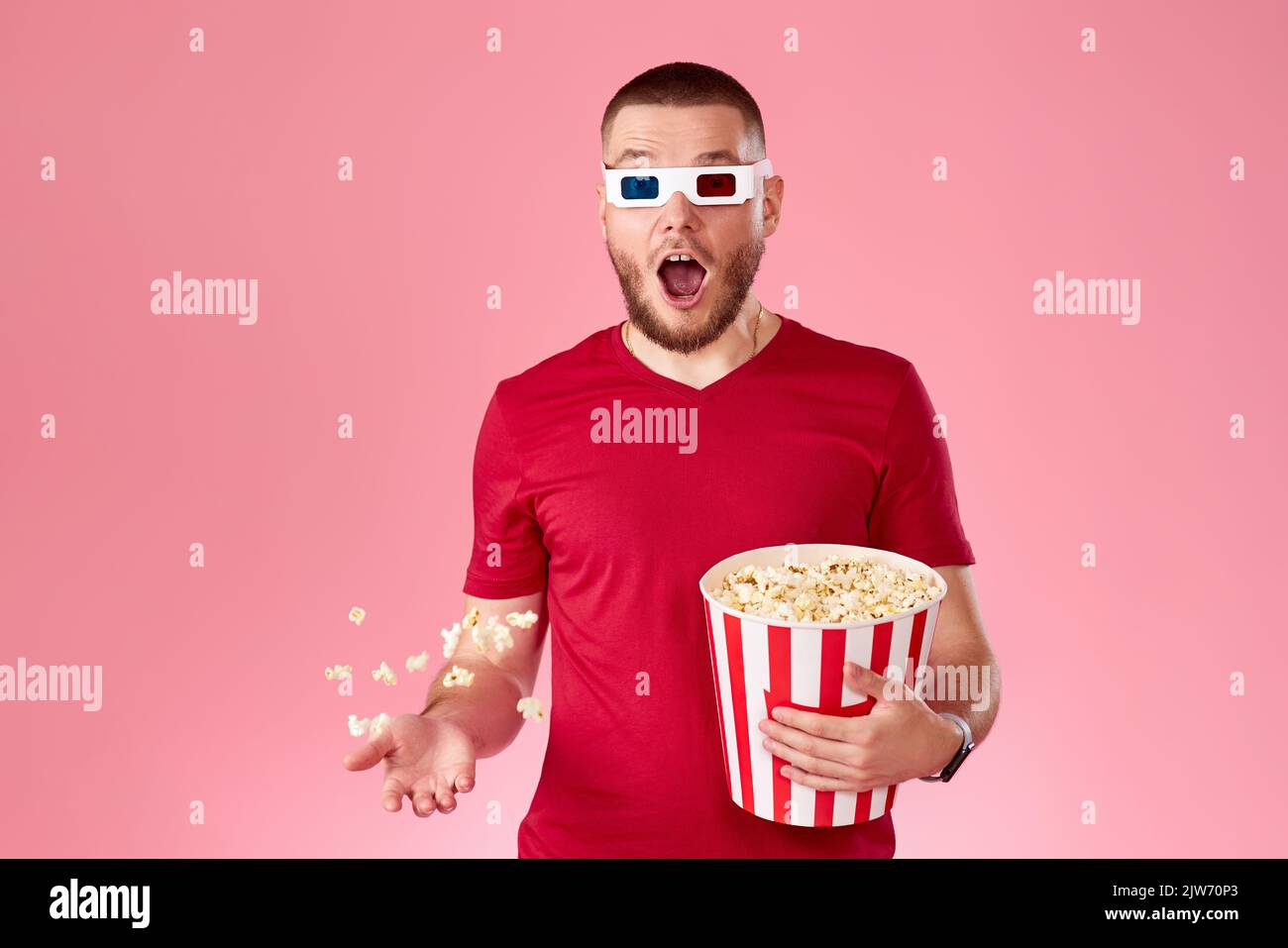 young man in 3d glasses throwing up and eating popcorn Stock Photo - Alamy