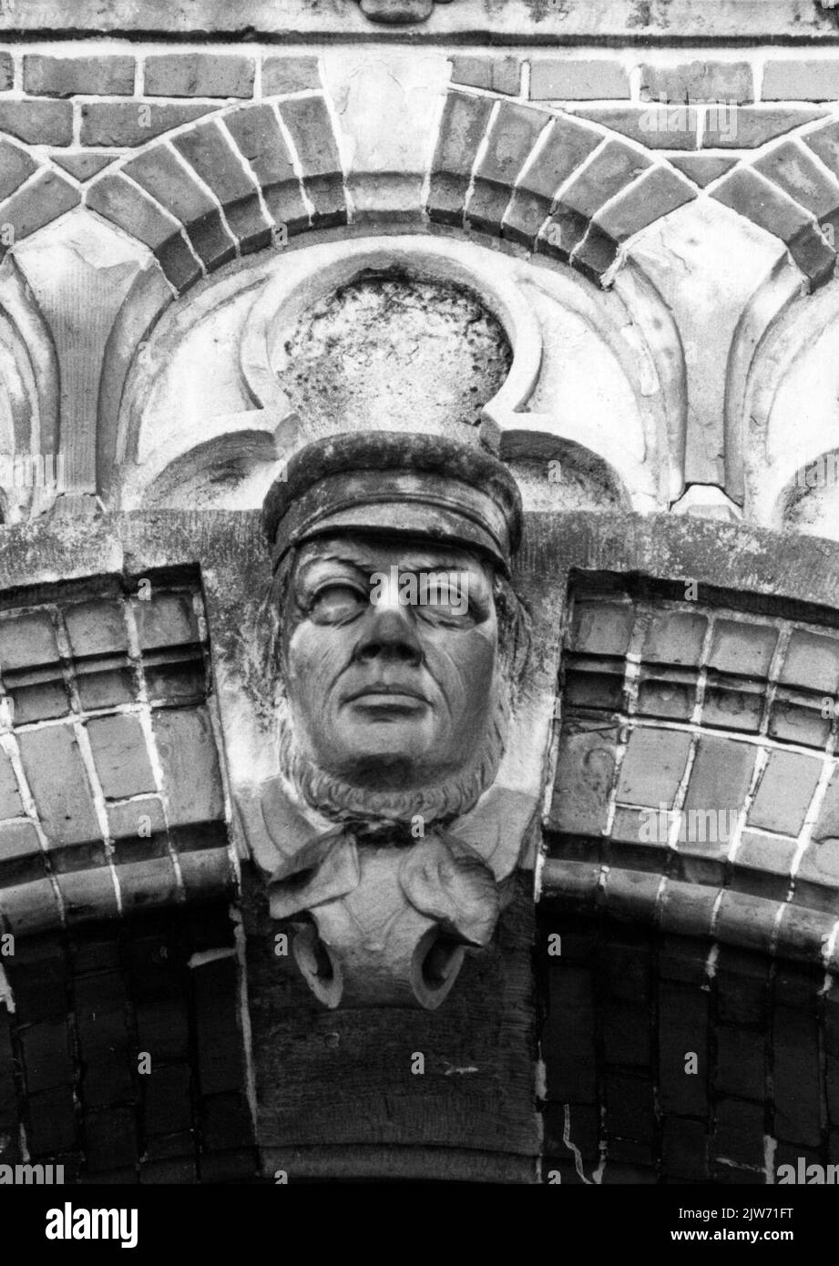 Image of a keystone with a sculpted head of a farmer above an arcade of ...