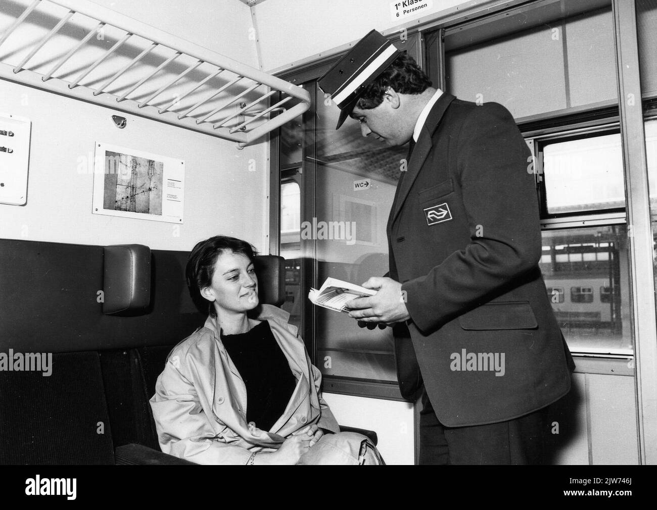 Image of a conductor and a train traveler in a 1st class coupé of a ...