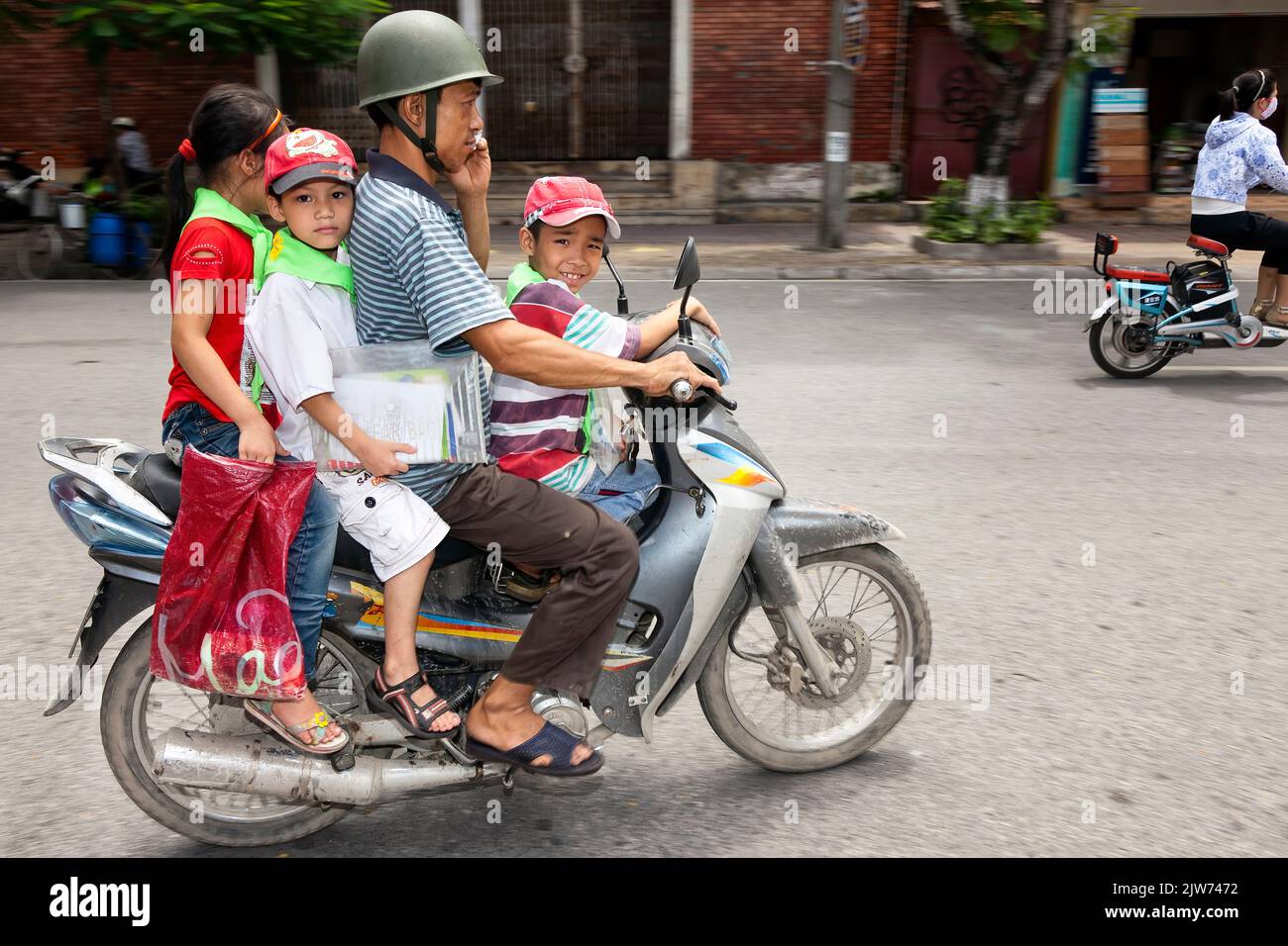 Four members of Vietnamese family on motorbike, Hai Phong, Vietnam ...