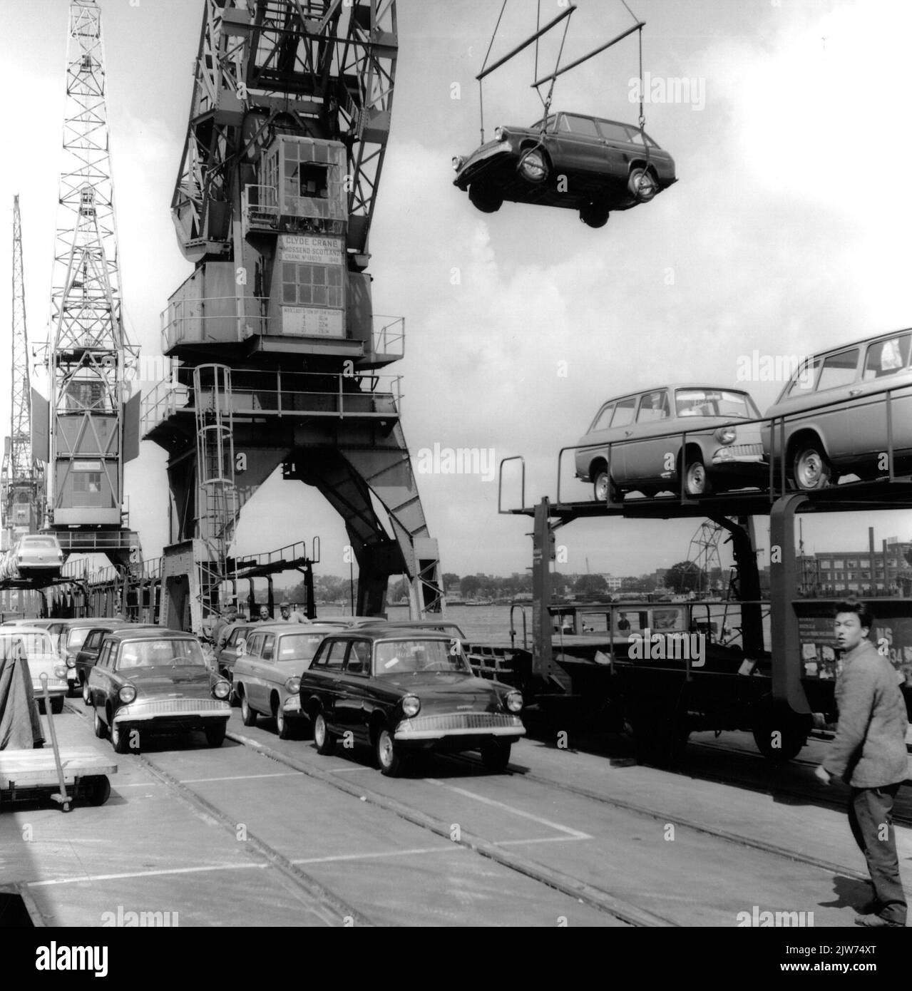 Image of overloading passenger cars (Ford Anglias) from a ship to train ...