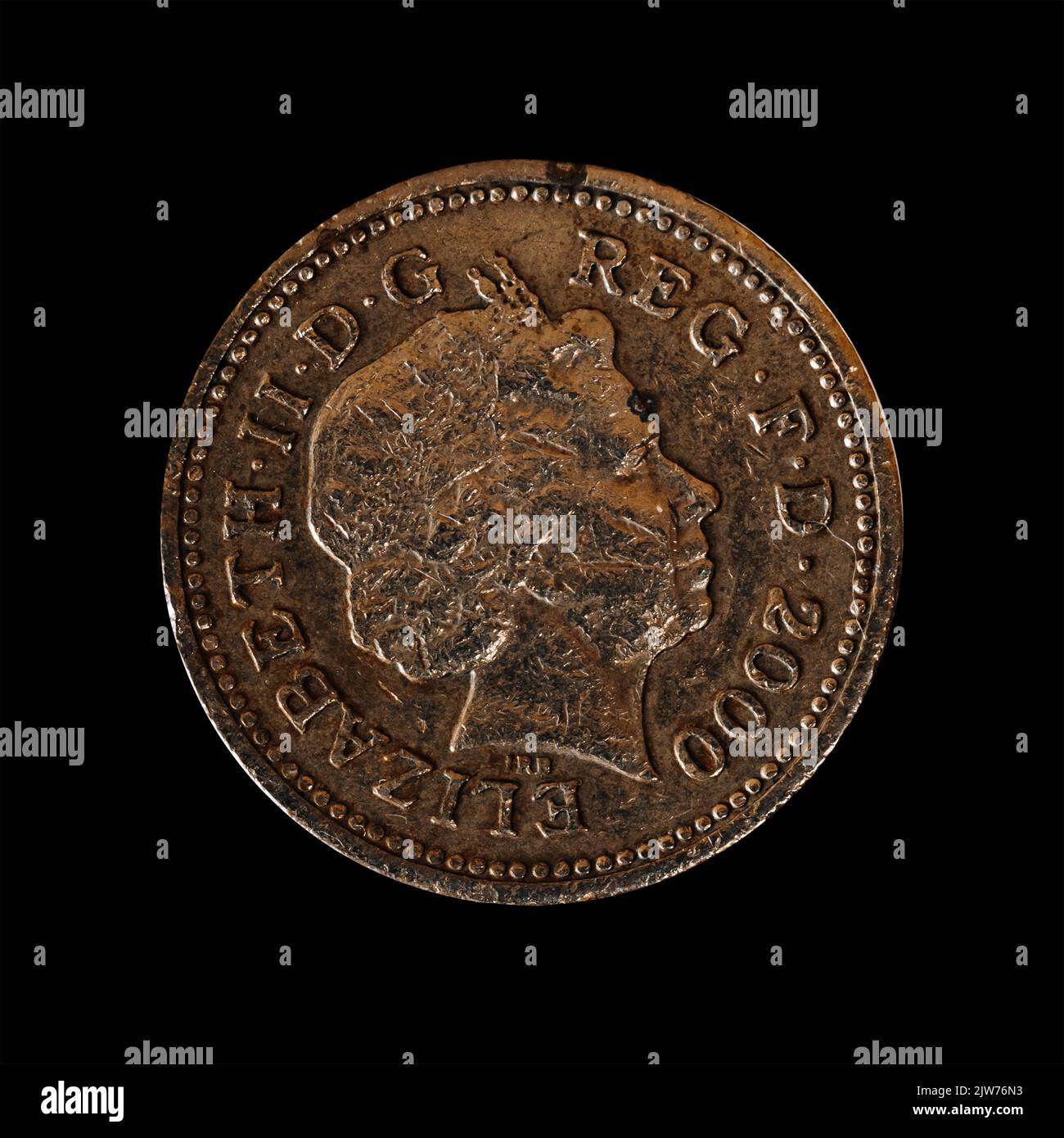 A closeup of a 2 pence coin from 2000 isolated on a black background ...