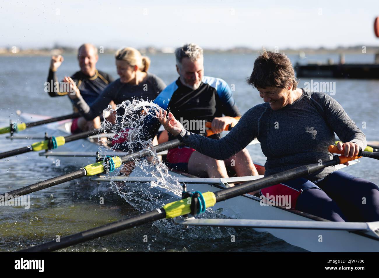 Senior caucasian rowing team having fun while rowing the boat on the ...