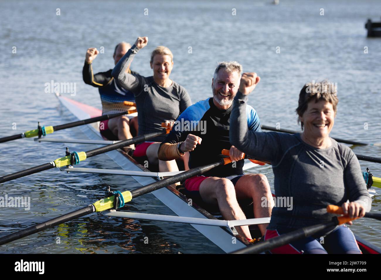 Senior caucasian rowing team having fun while rowing the boat on the ...