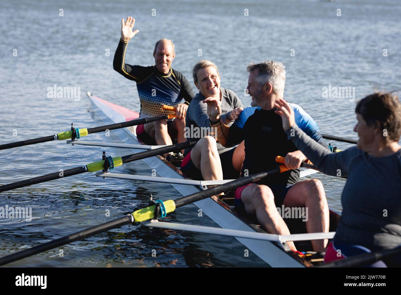 Senior caucasian rowing team having fun while rowing the boat on the ...