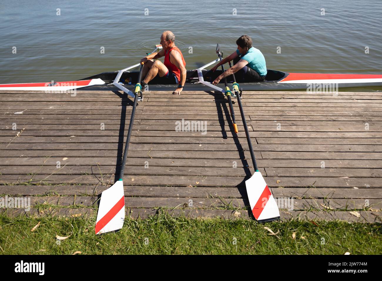 Happy couple rowing wooden boat hi-res stock photography and images - Alamy