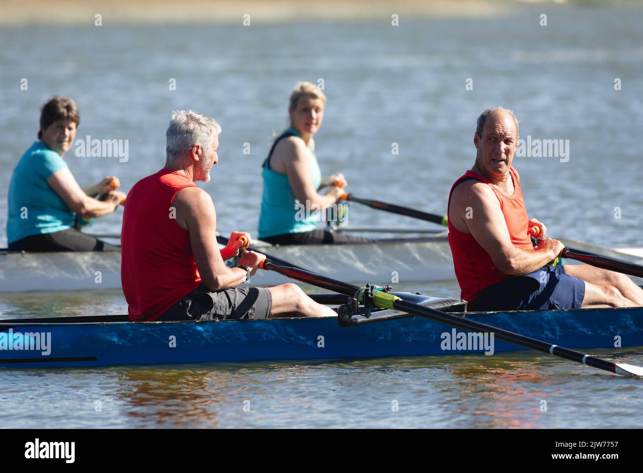 Two senior caucasian rowing teams rowing the boat on the lake Stock ...