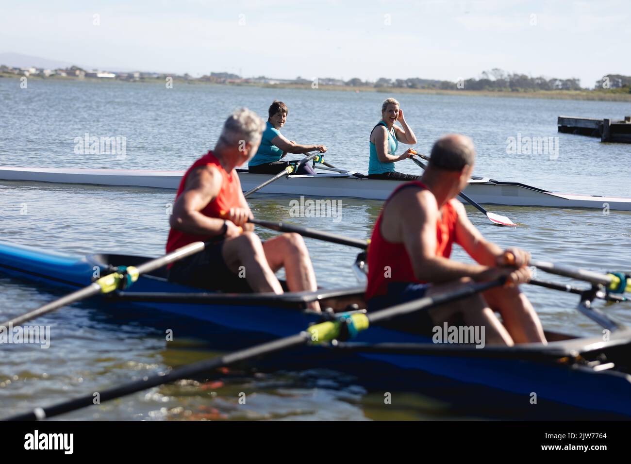 Two senior caucasian rowing teams rowing the boat on the lake Stock ...