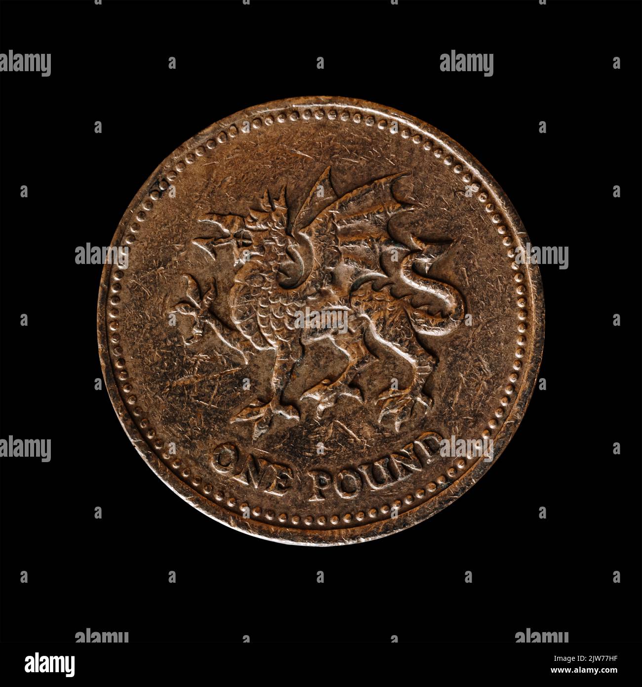 A closeup of a 1 pound coin from 2000 isolated on a black background ...