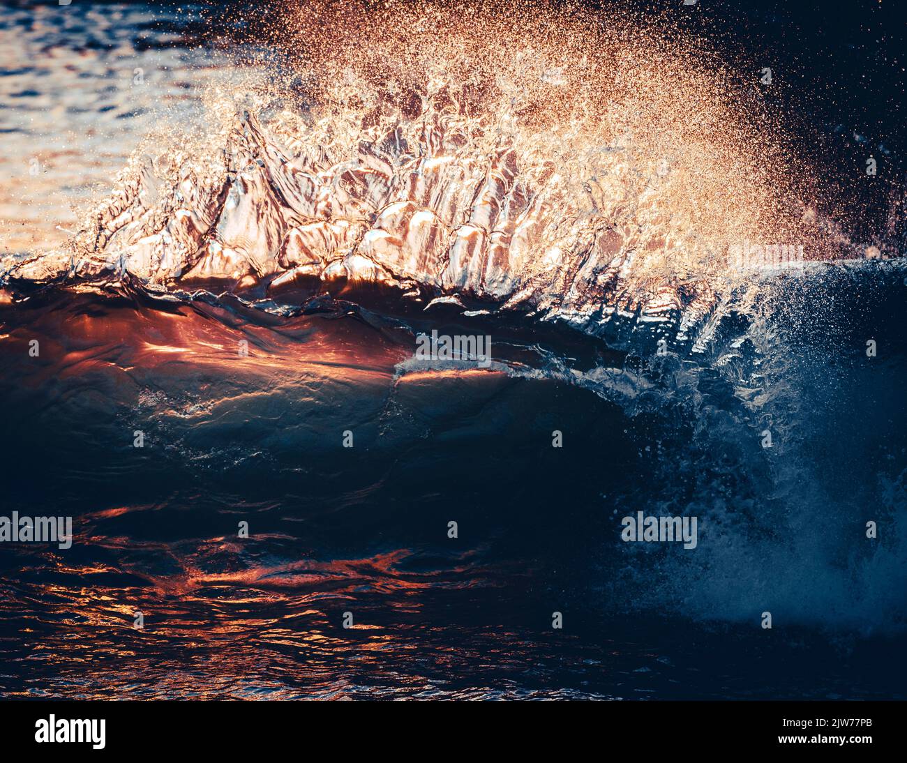 Crisp Cornish waves rising up from the reef of Porthleven at sun set ...