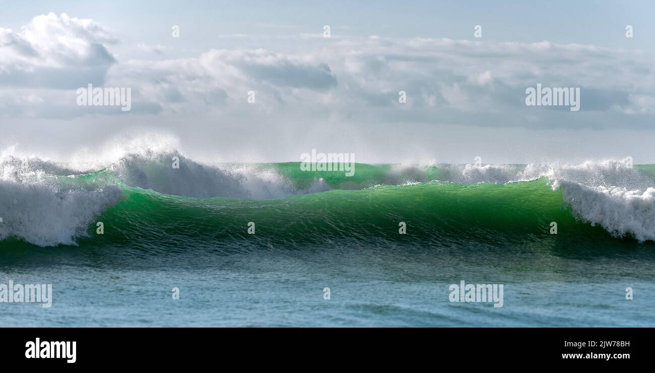 Double wave rolling into Praa sands beach Stock Photo - Alamy