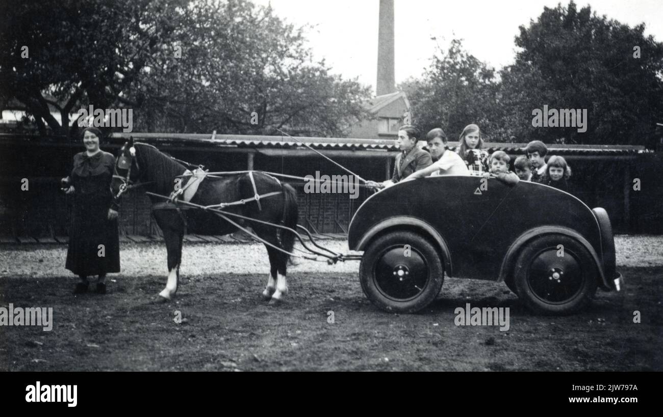 Image of the children of the Trapman family in a car drawn by a horse ...