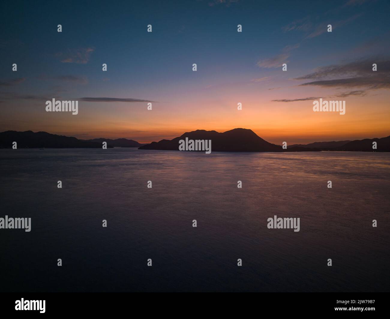Small island mountain off coast before dawn Stock Photo - Alamy