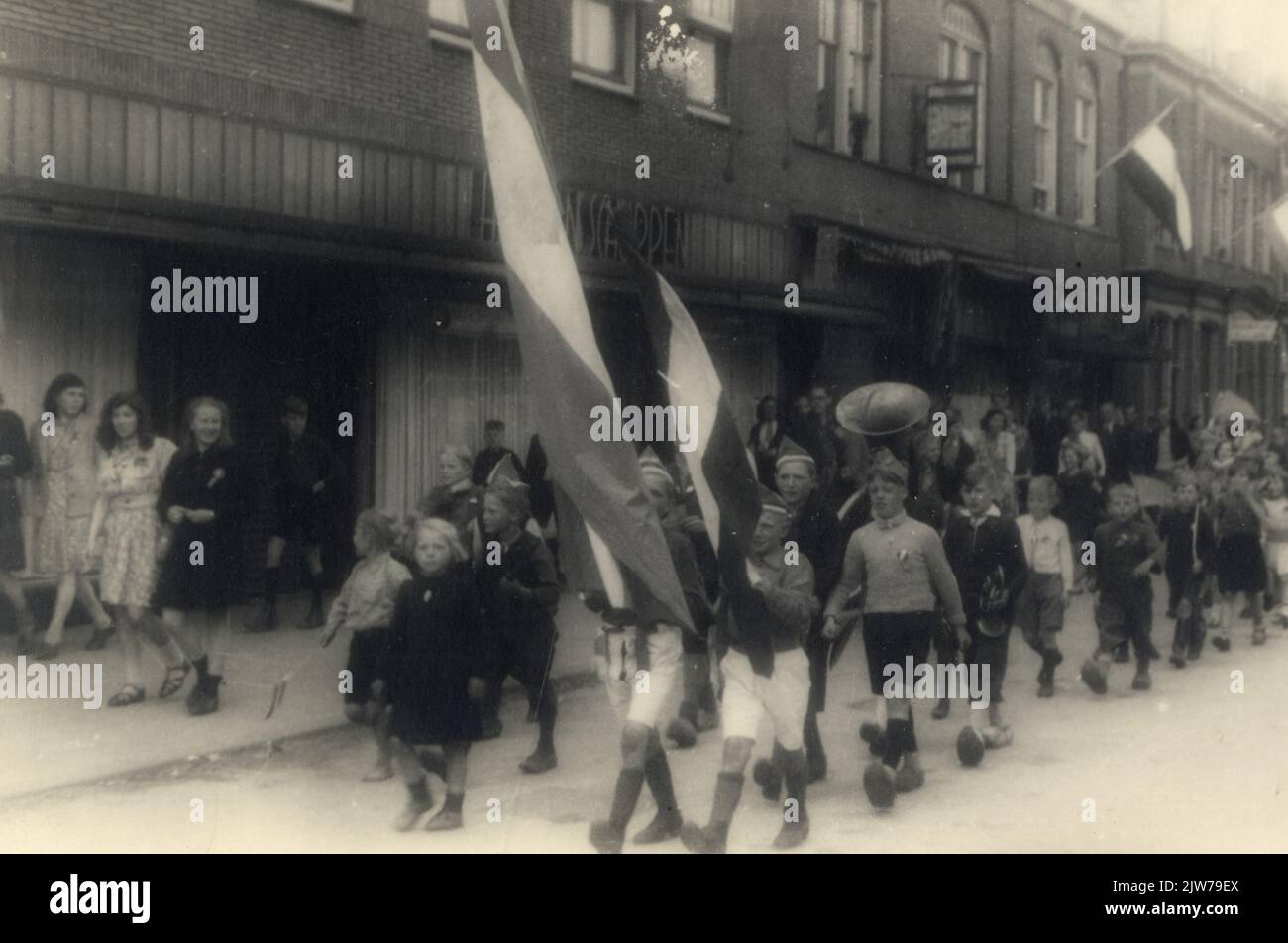 Image of a group of marching children with flags in the Hoofdstraat in ...