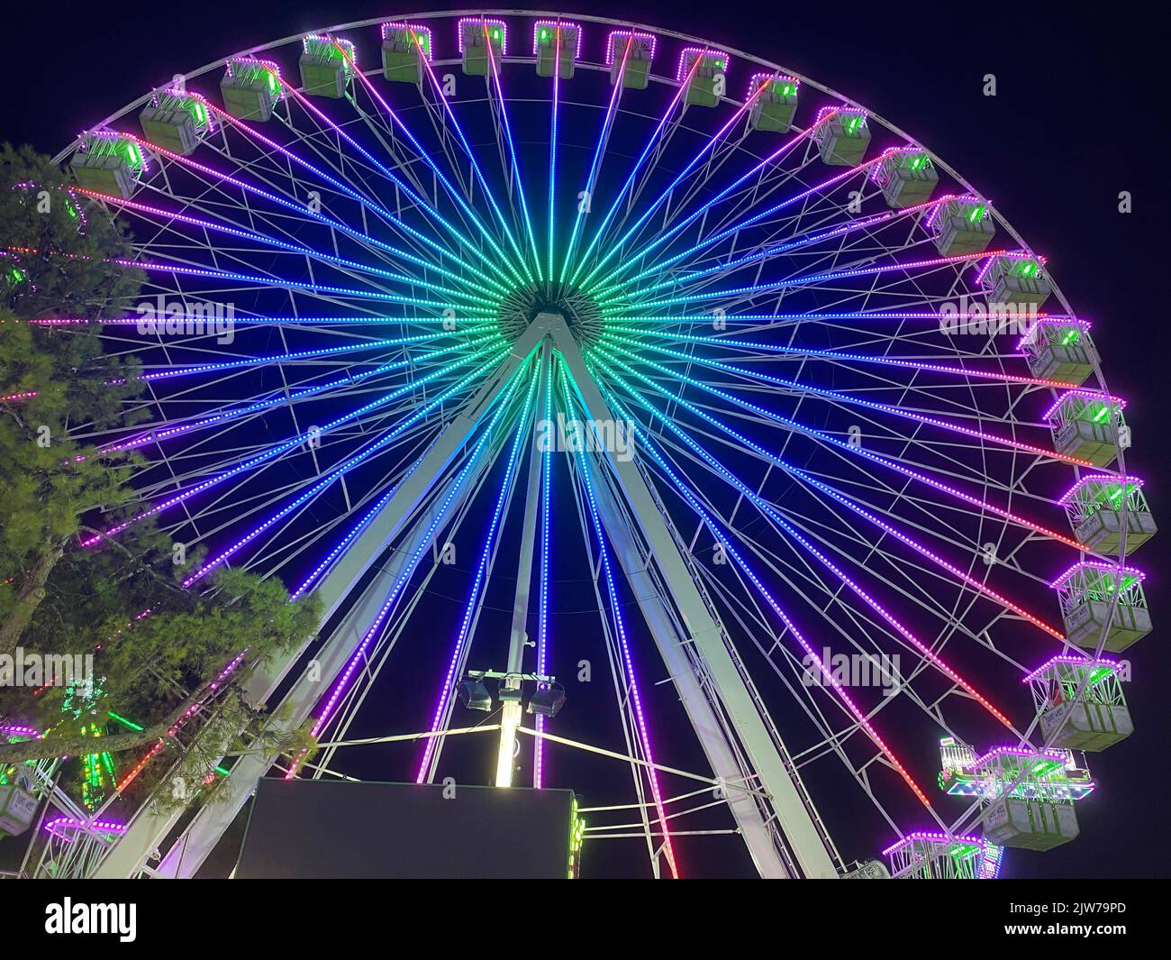 Illuminated ferris wheel at night. Colorful giant ferris wheel at ...