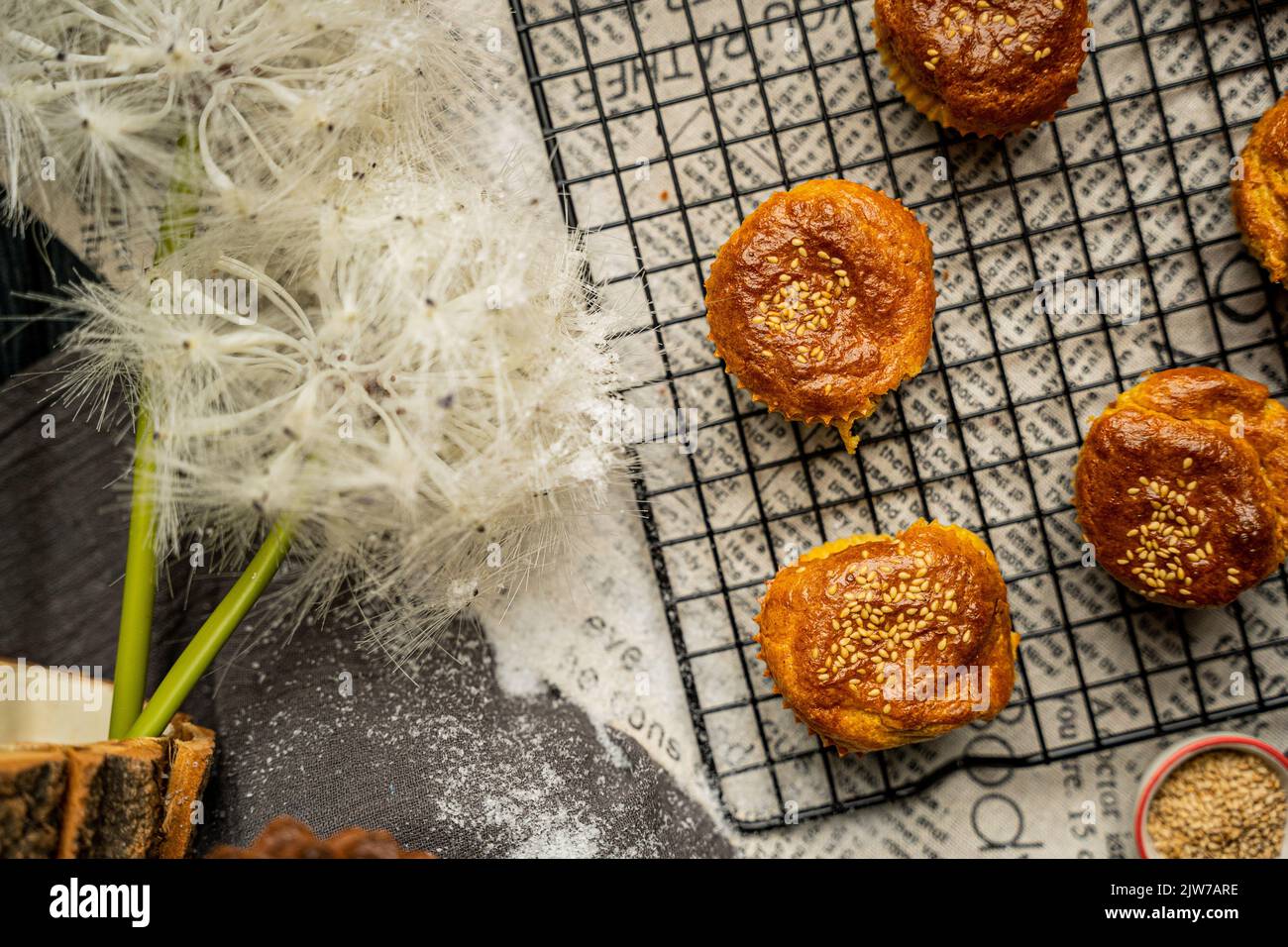 A top view of Sesame muffins placed on a tray with decorative white ...