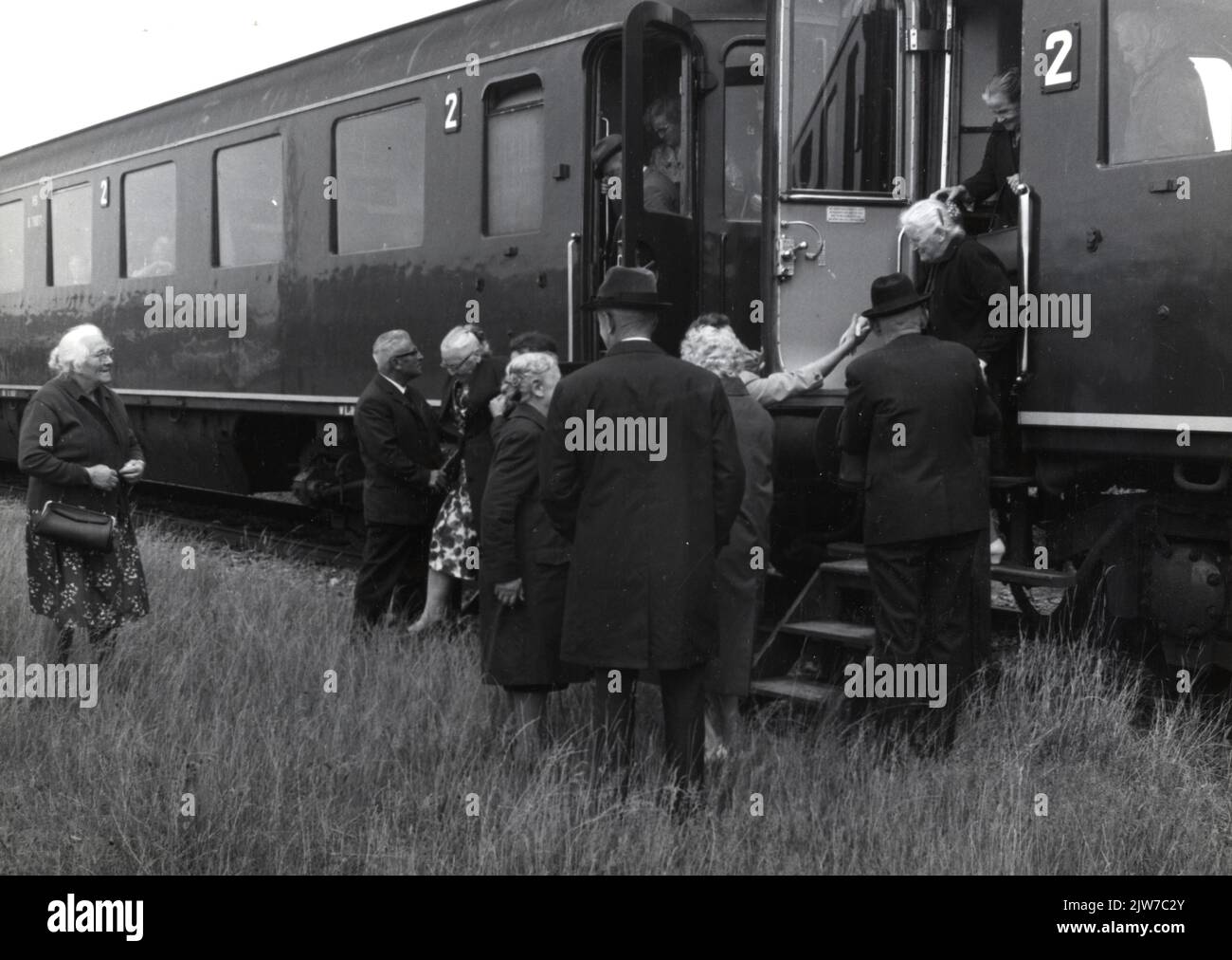 Image of a group of elderly people while getting out of the extra train ...
