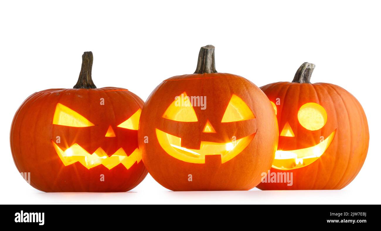 Three Halloween glowing lantern pumpkins in a row isolated on white ...