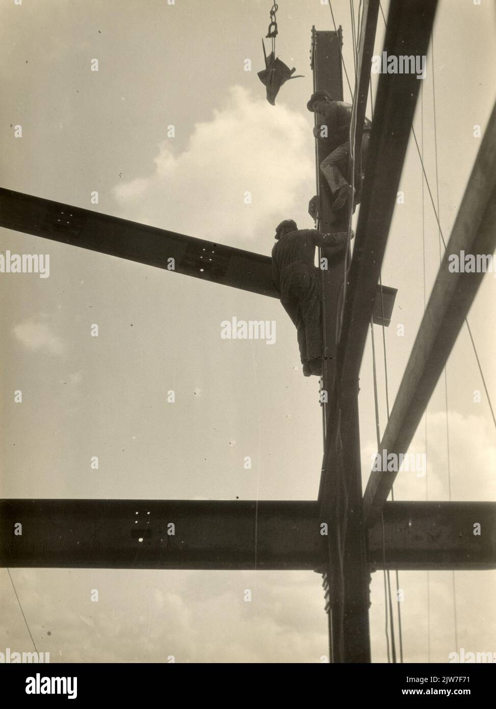 Image of two construction workers while setting the steel skeleton for ...