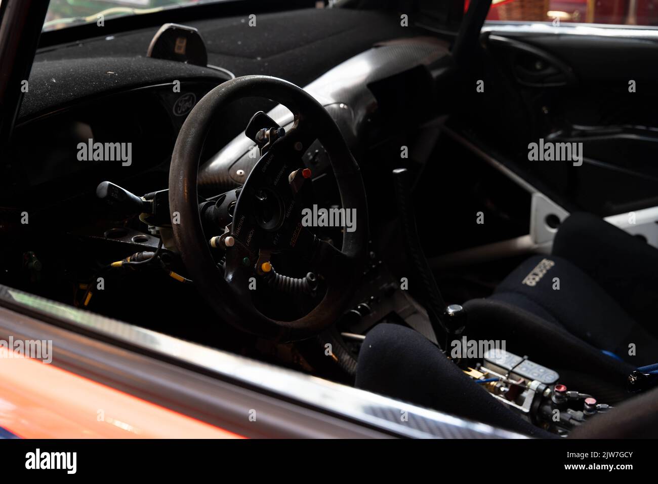 Classic racing car interior with vintage steering wheel and dashboard ...