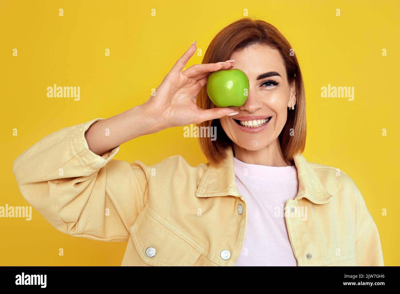 girl holding green apple isolated on white background Stock Photo - Alamy
