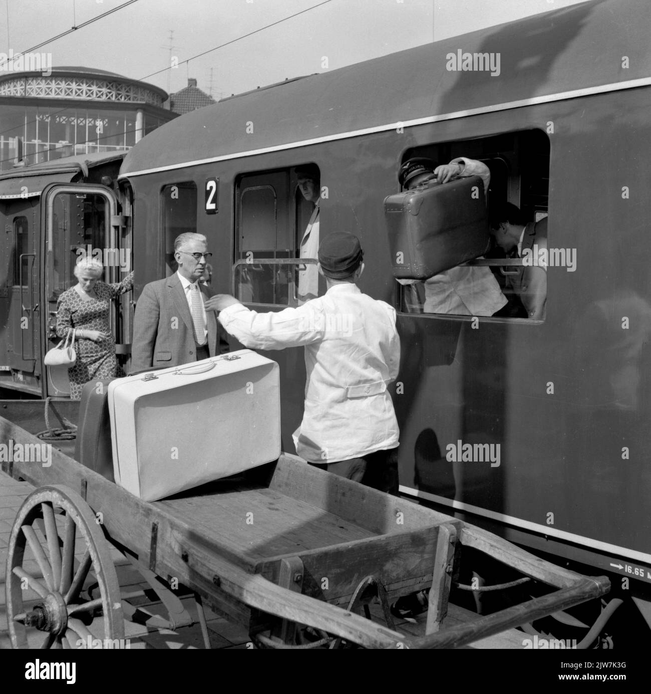 Image of a porter while loading the luggage in a train along the ...