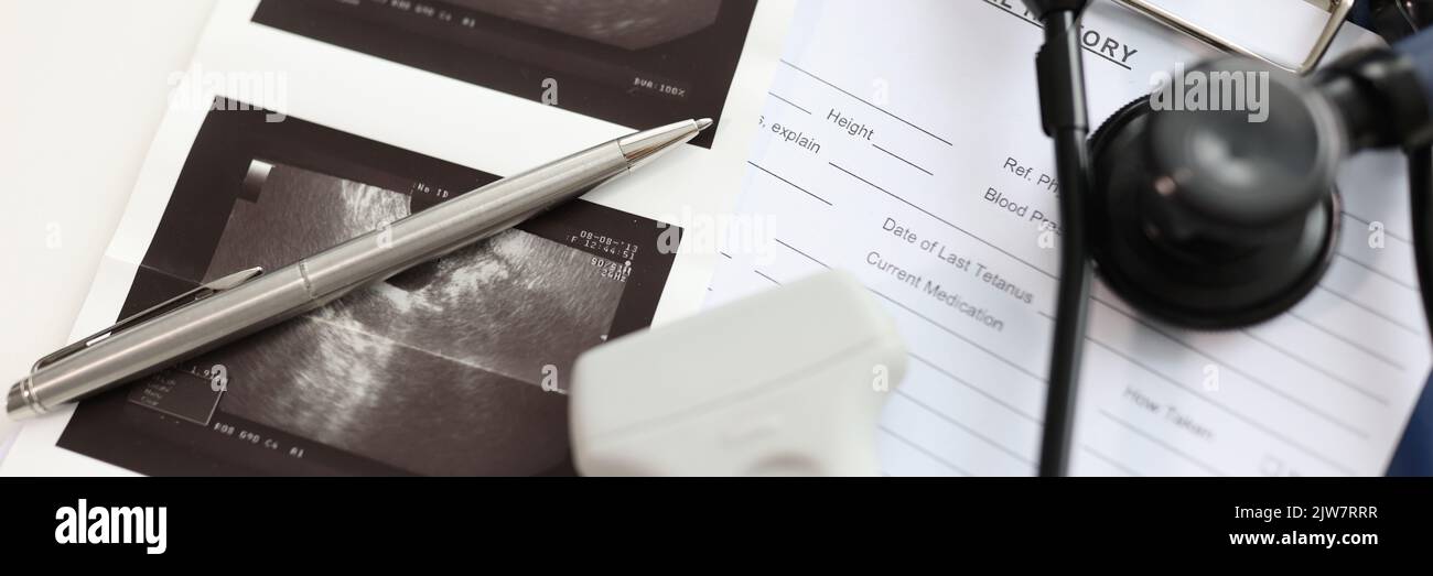 Ultrasound sensor with pictures and stethoscope lying on patient ...