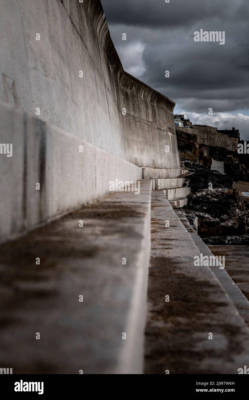 Sea defence wall of Porthleven beach Stock Photo - Alamy