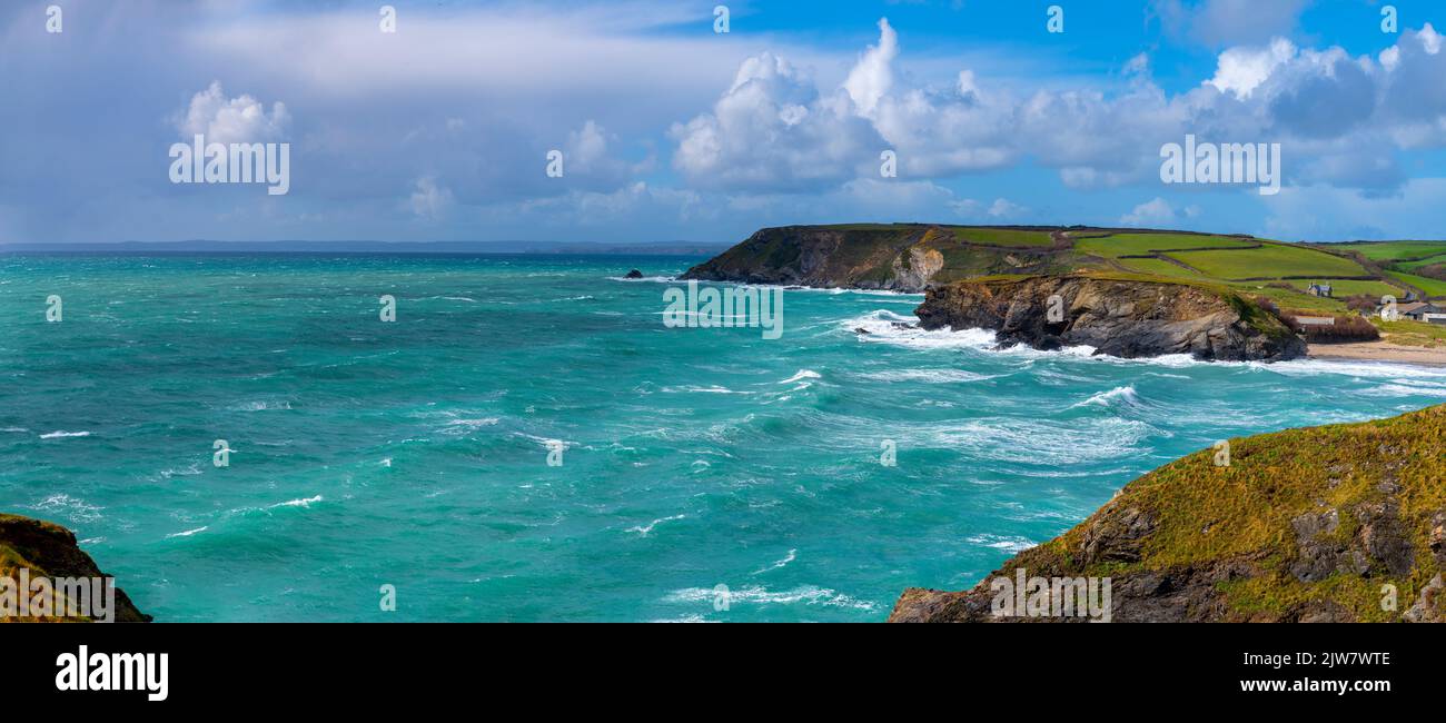 Rough waters down Church Cove Cornwall. Turquoise coloured sea, blue ...