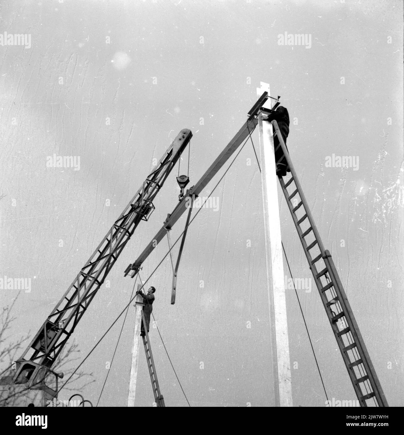 Image of placing the upper bar for an overhead pipe portal, during the ...