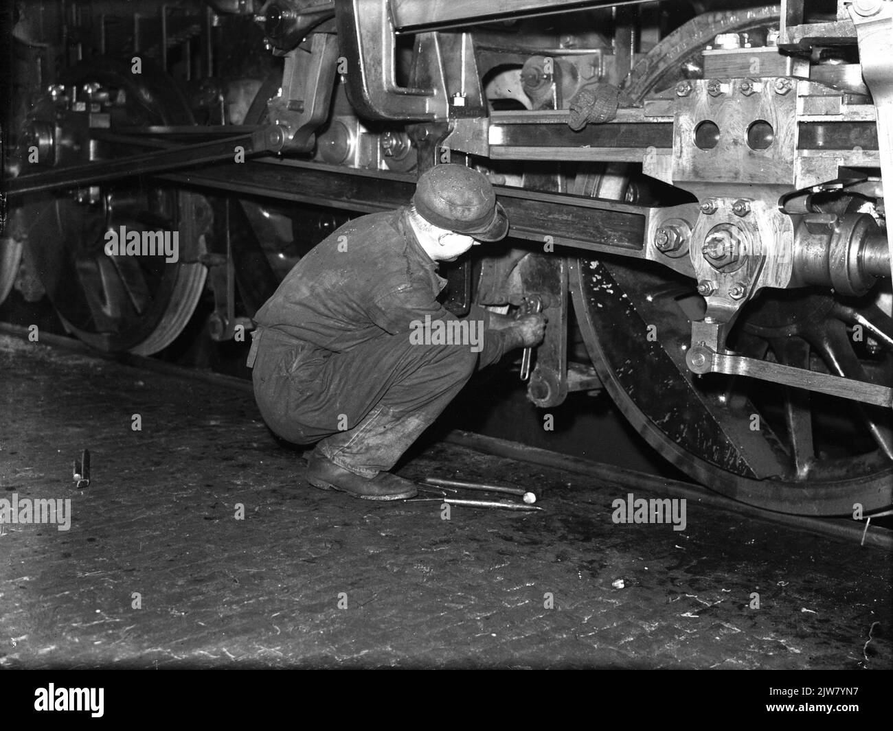 Image of a technician who carries out maintenance under the running of ...