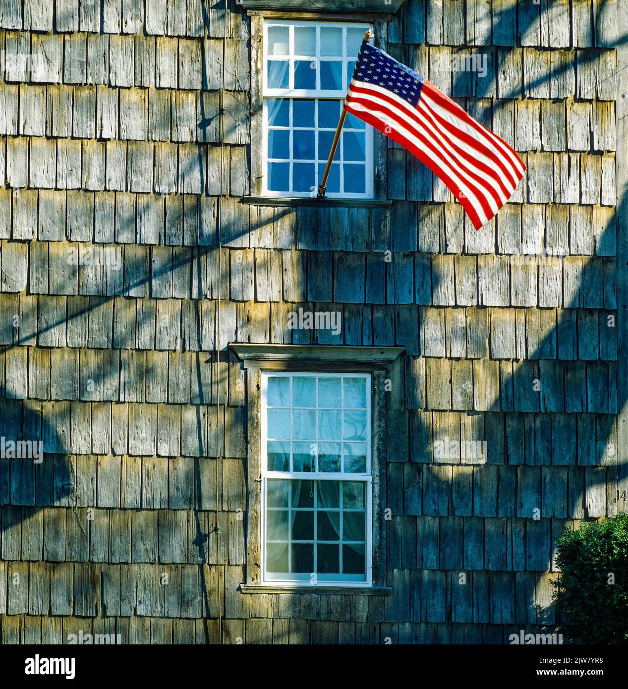 New York, 1980s, flying US flag, 2 windows, wood shingled house facade ...
