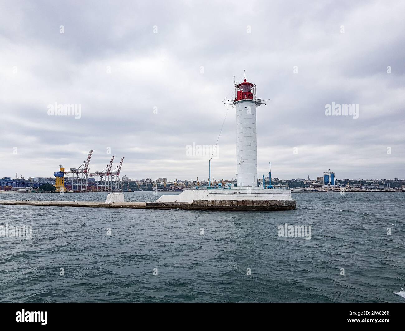 Seascape Sea with lighthouse, calm water and white clouds background ...