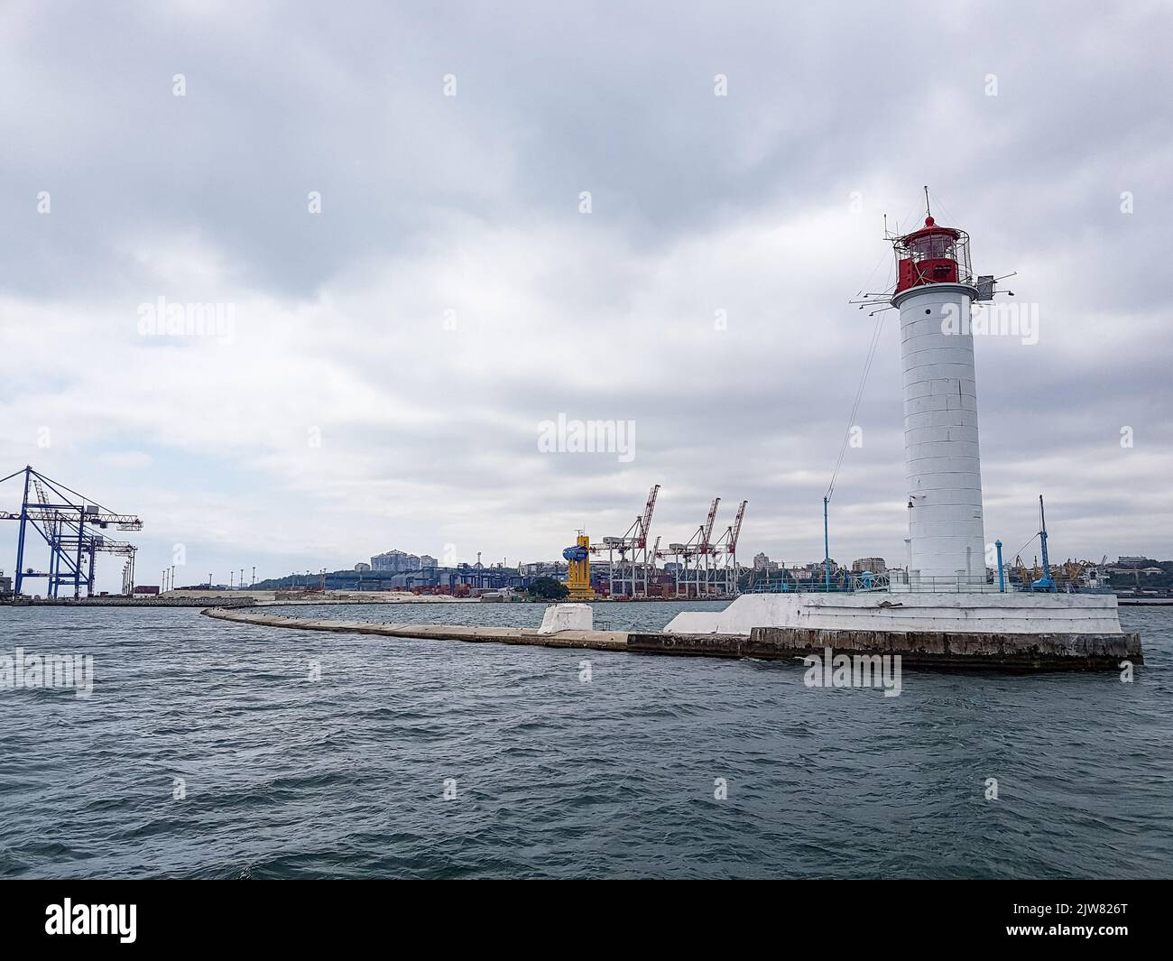 Seascape Sea with lighthouse, calm water and white clouds background ...