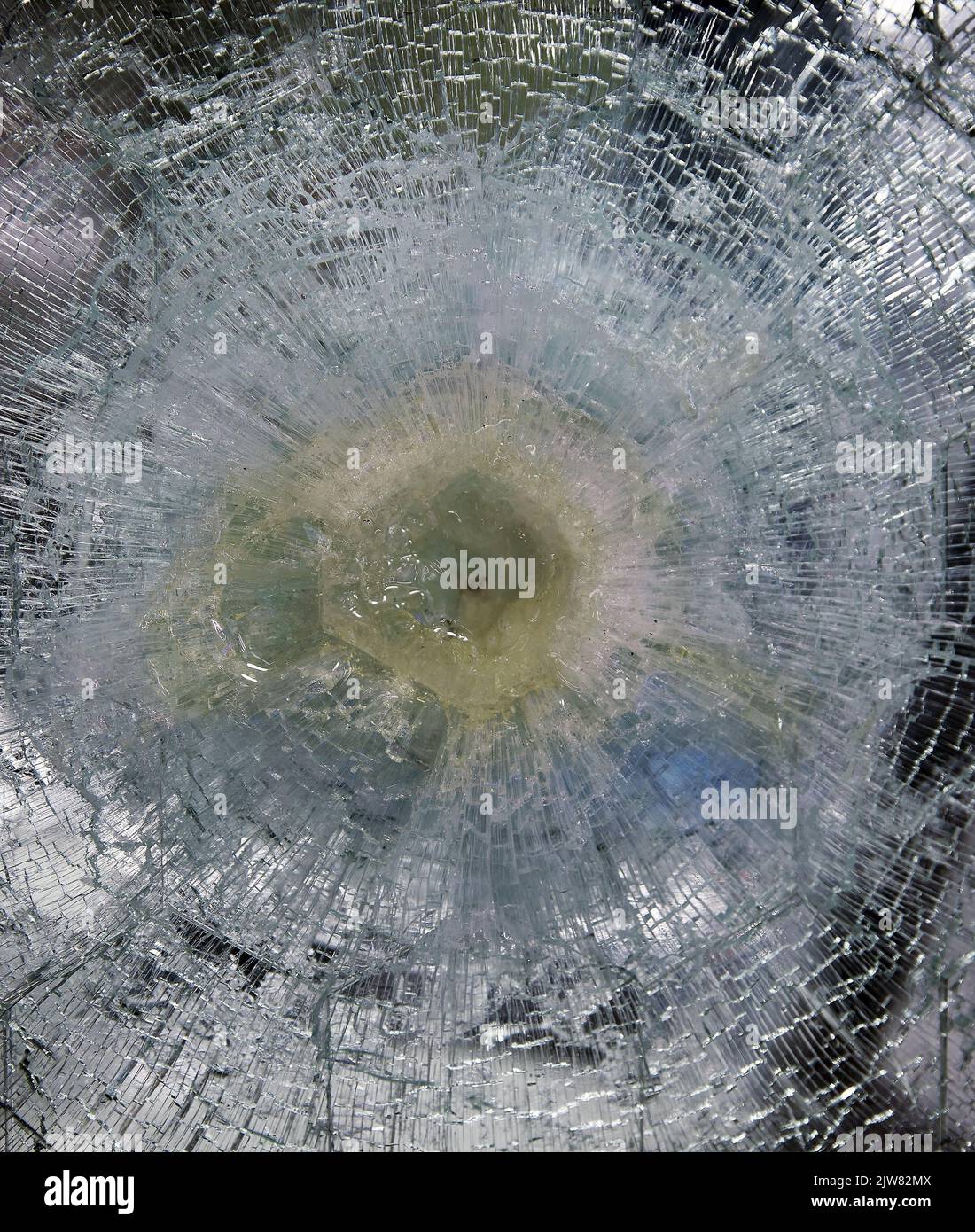 Bulletproof glass after test. bulletproof glass with cracks and a ...