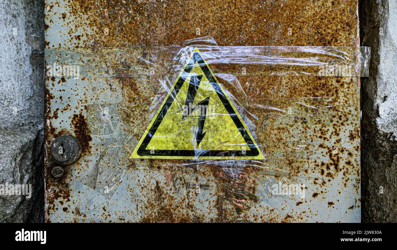 Rusty electrical panel door tied with scotch tape Electrical hazard ...