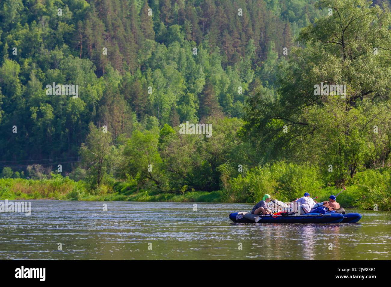 A group of tourists is rafting on an inflatable catamaran along the ...
