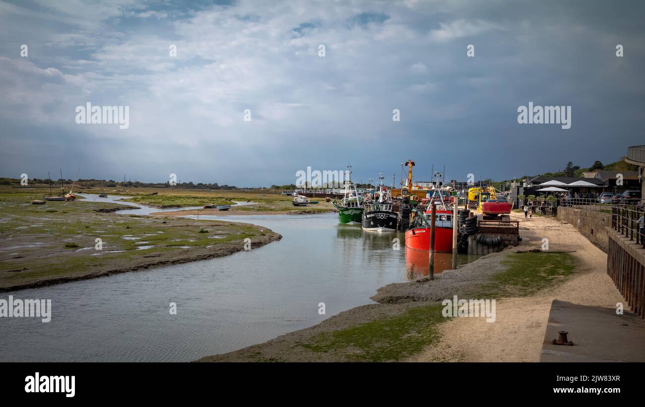 Cockle fishing boats tied up at at low tide at their home port of Leigh ...