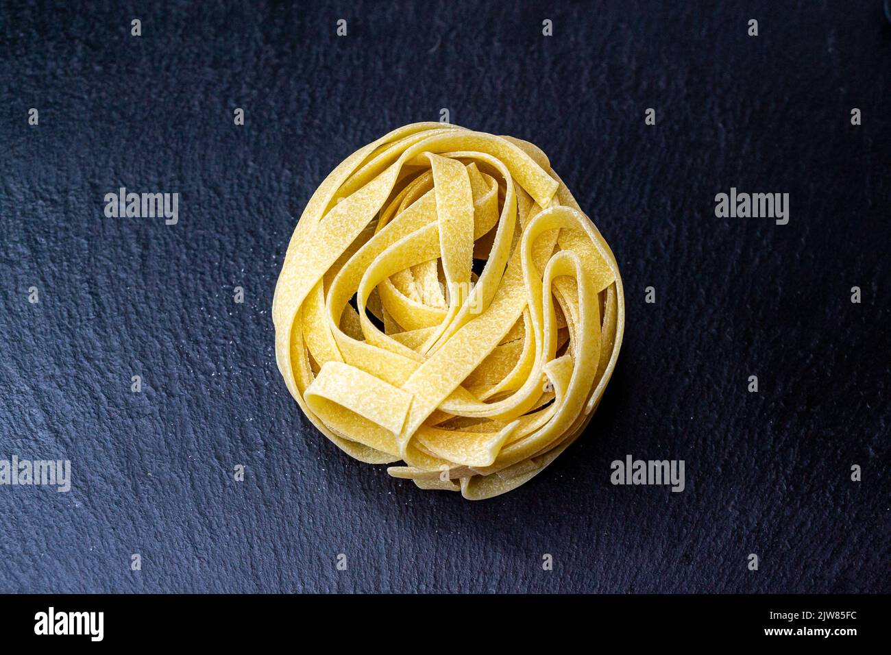 Dry Italian tagliatelle pasta background healthy food photo Top view ...