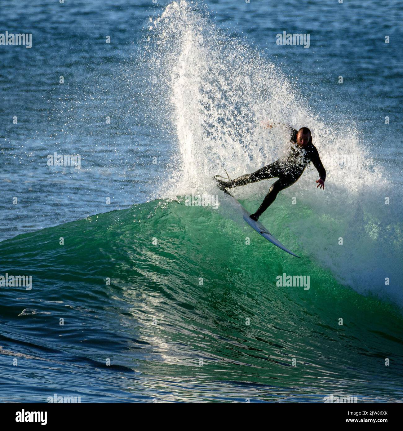 Surfer enjoying the amazing barrelling waves on Porthleven reefs ...