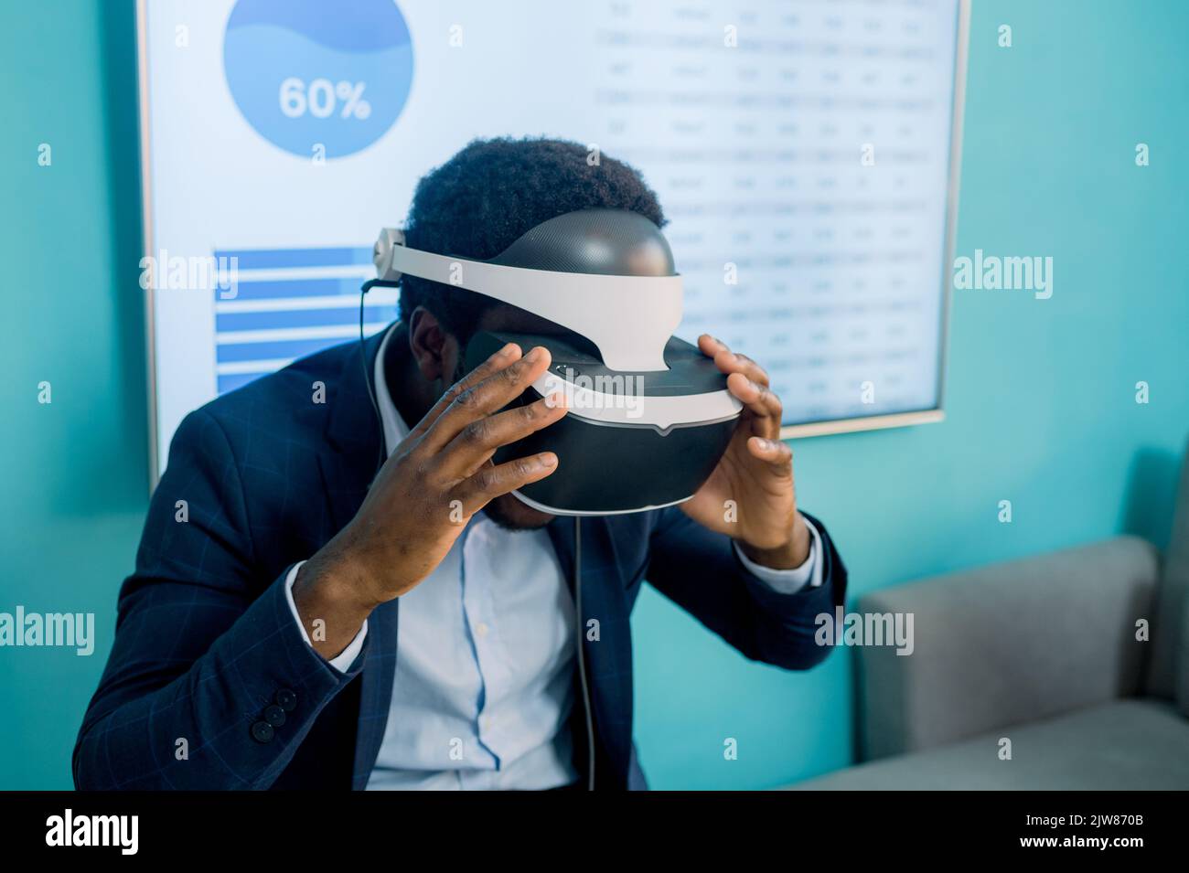 Black businessman experiencing virtual reality in modern headset Stock Photo - Alamy