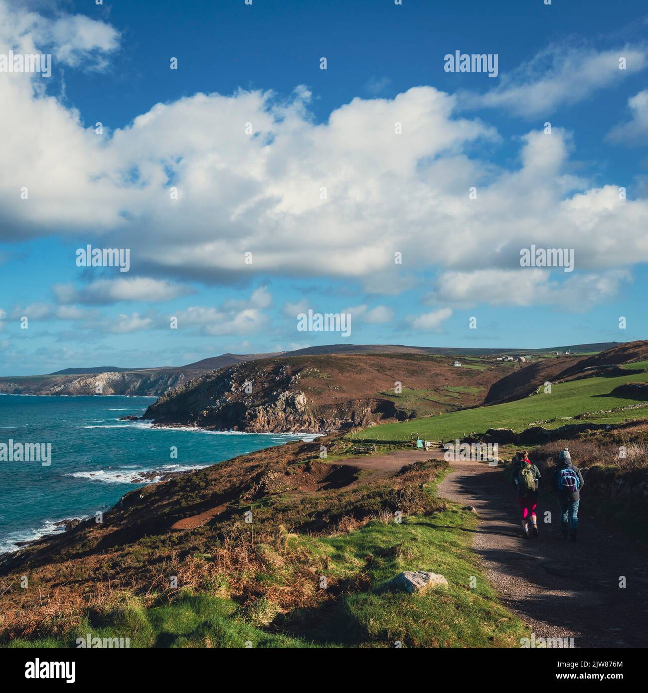 2 hikers taking the coast path from Pendeen Lighthouse Stock Photo - Alamy