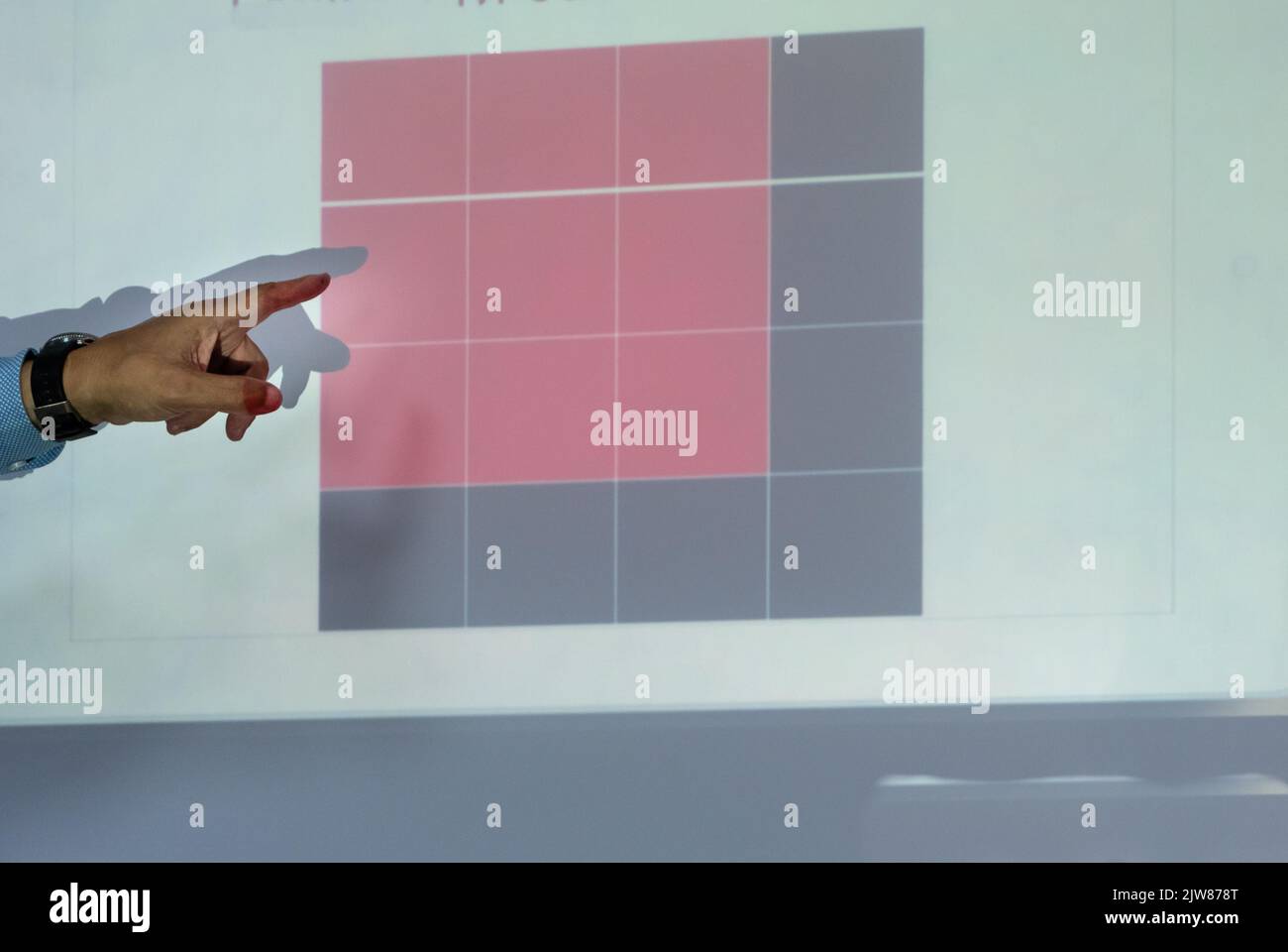 Index finger of outstretched hand on background of slide of squares on ...