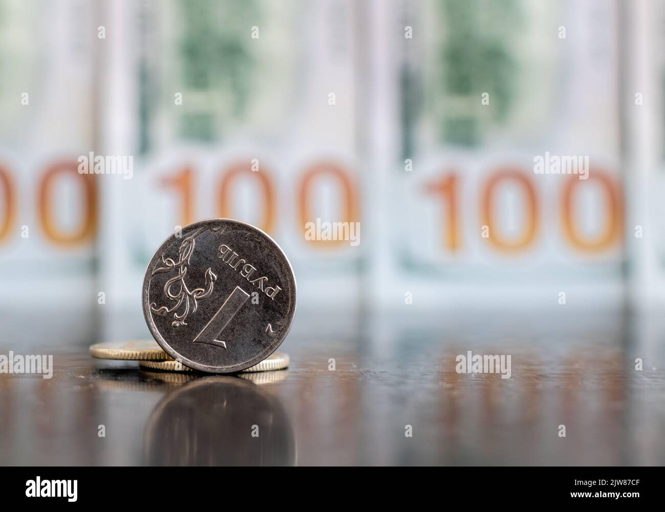 1 russian ruble coin close-up on blurred background of dollars ...
